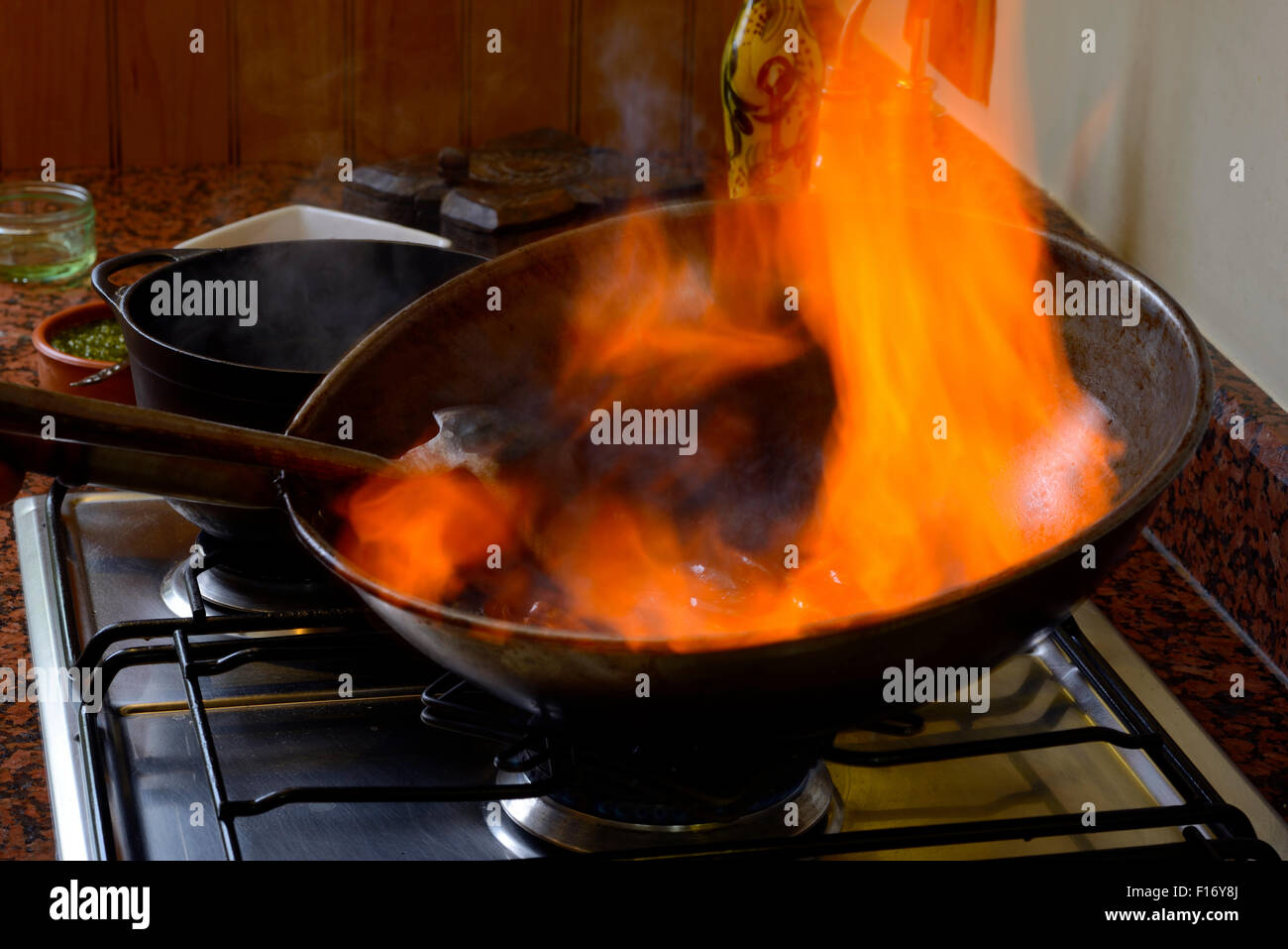 Flambé in a wok Stock Photo - Alamy