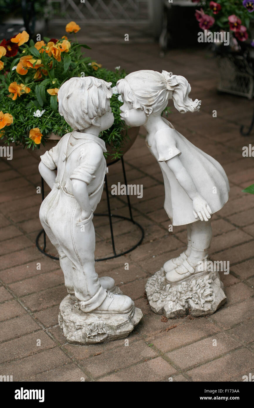 Cement children garden kiss plaster sculpture statue Stock Photo - Alamy