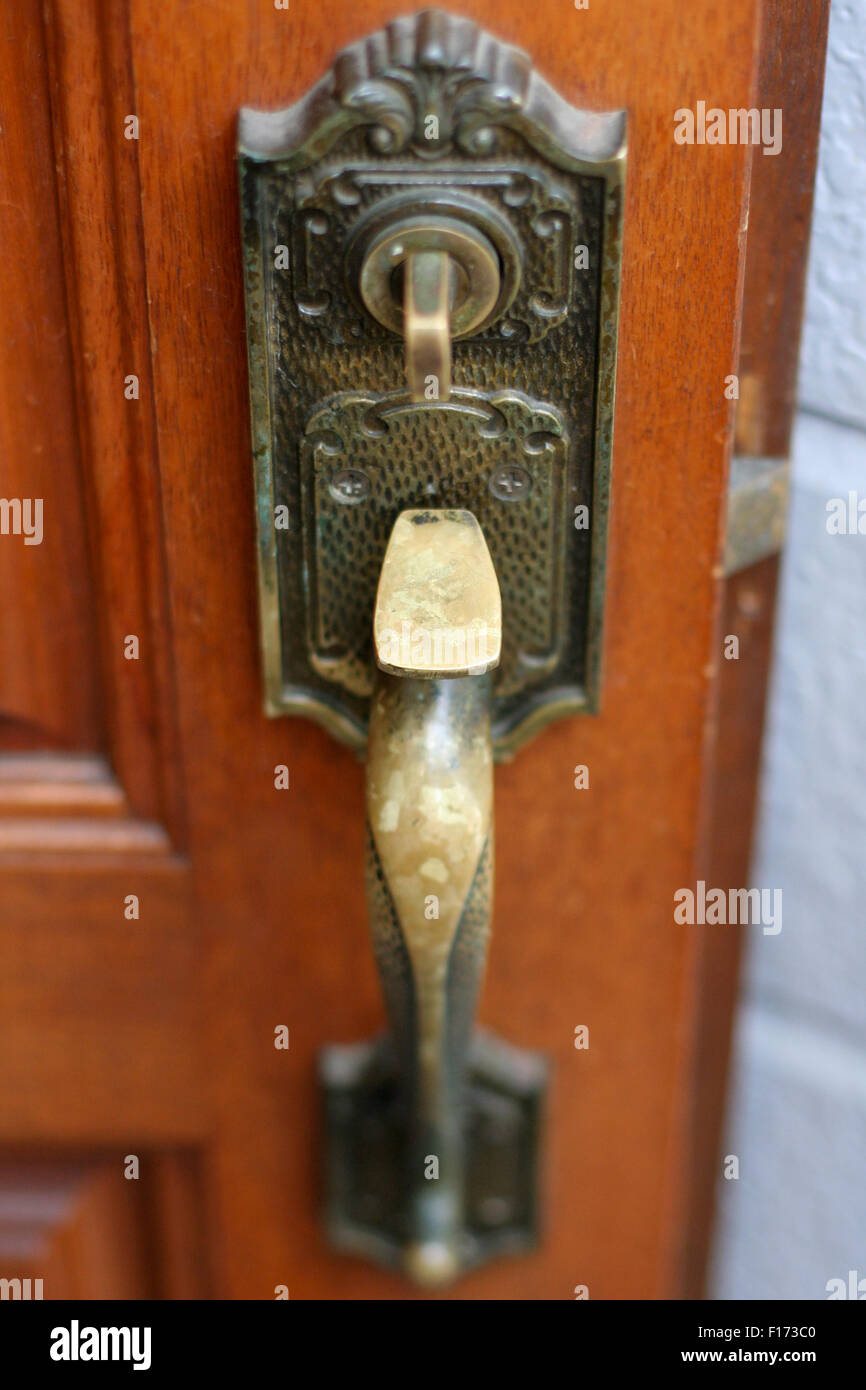 Brass door handle with lock switch atop Stock Photo - Alamy