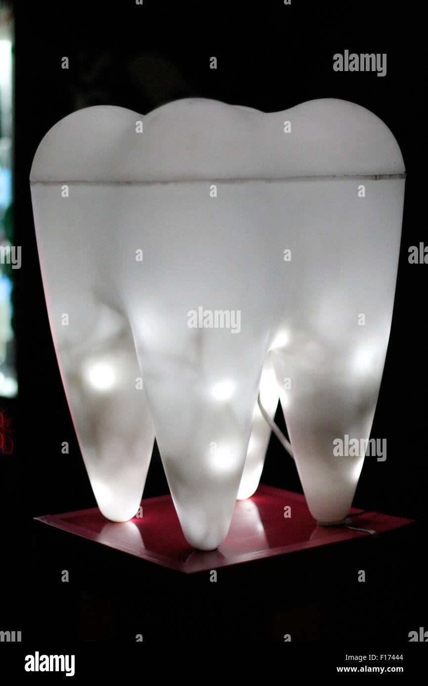 Tooth light on glossy block Stock Photo - Alamy