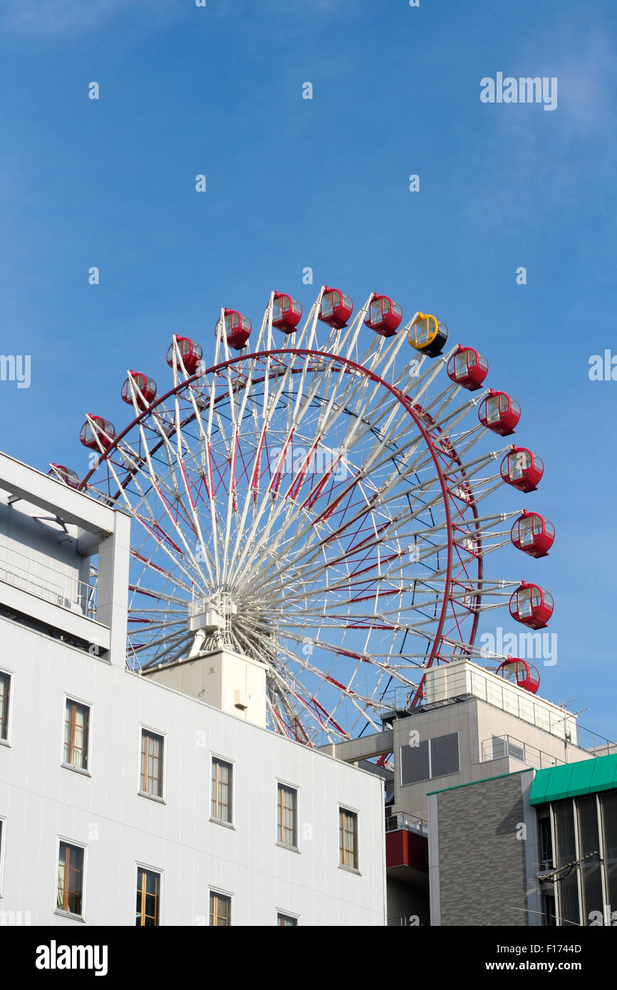 Ferris wheel above building view Stock Photo - Alamy