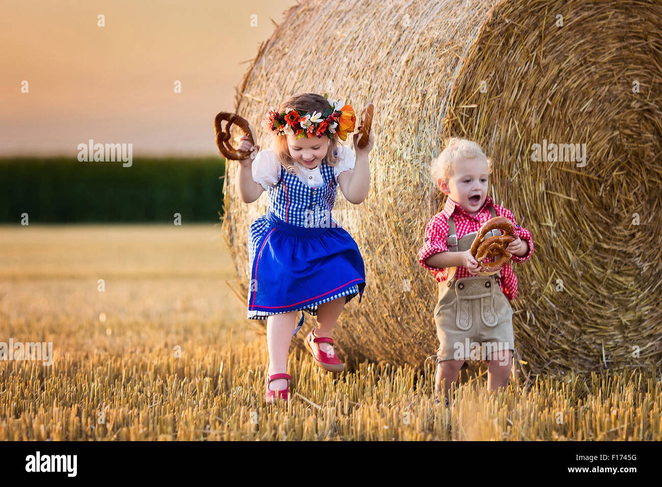 Kids in traditional Bavarian costumes in wheat field. German children ...