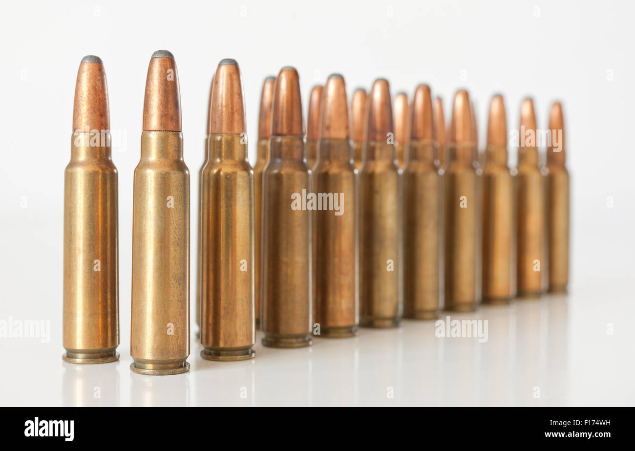 Group of rifle bullets on reflective white surface Stock Photo - Alamy