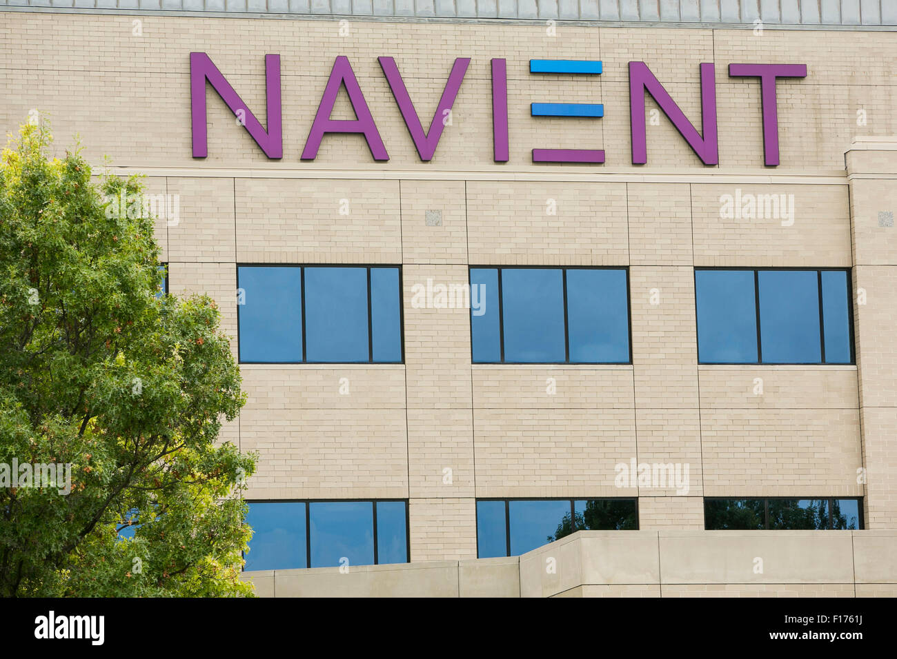 A logo sign outside of a facility occupied by the Navient Corporation ...