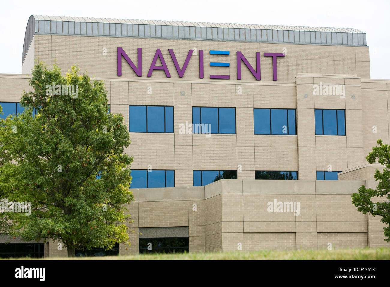 A logo sign outside of a facility occupied by the Navient Corporation ...