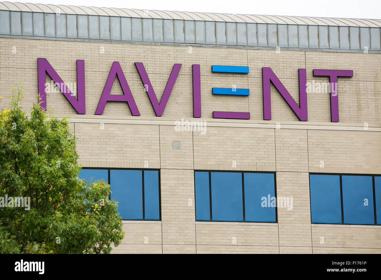 A logo sign outside of a facility occupied by the Navient Corporation ...