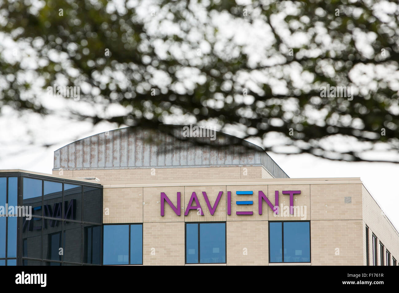 A logo sign outside of a facility occupied by the Navient Corporation ...