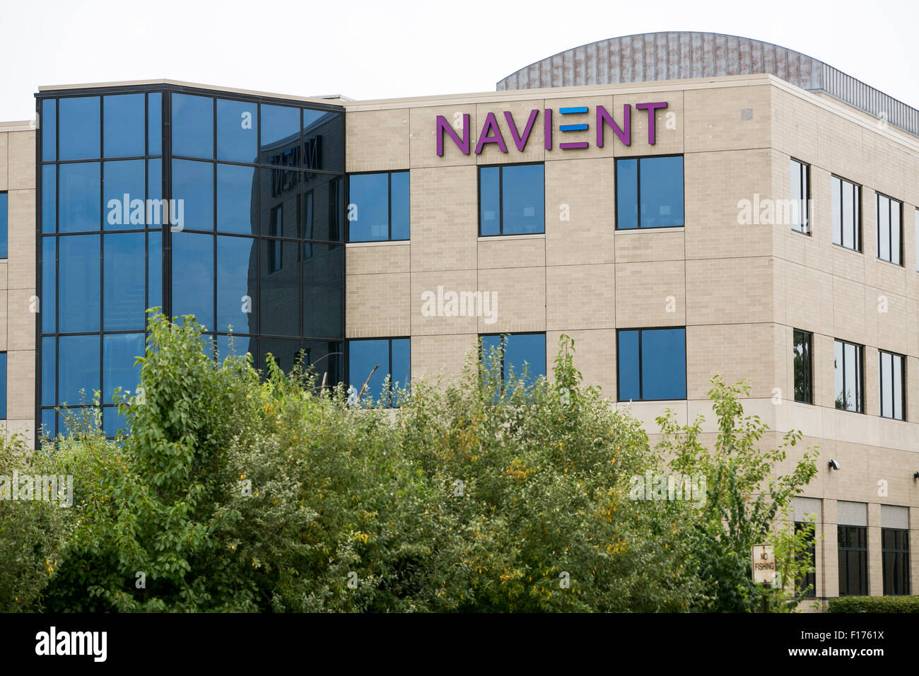 A logo sign outside of a facility occupied by the Navient Corporation ...