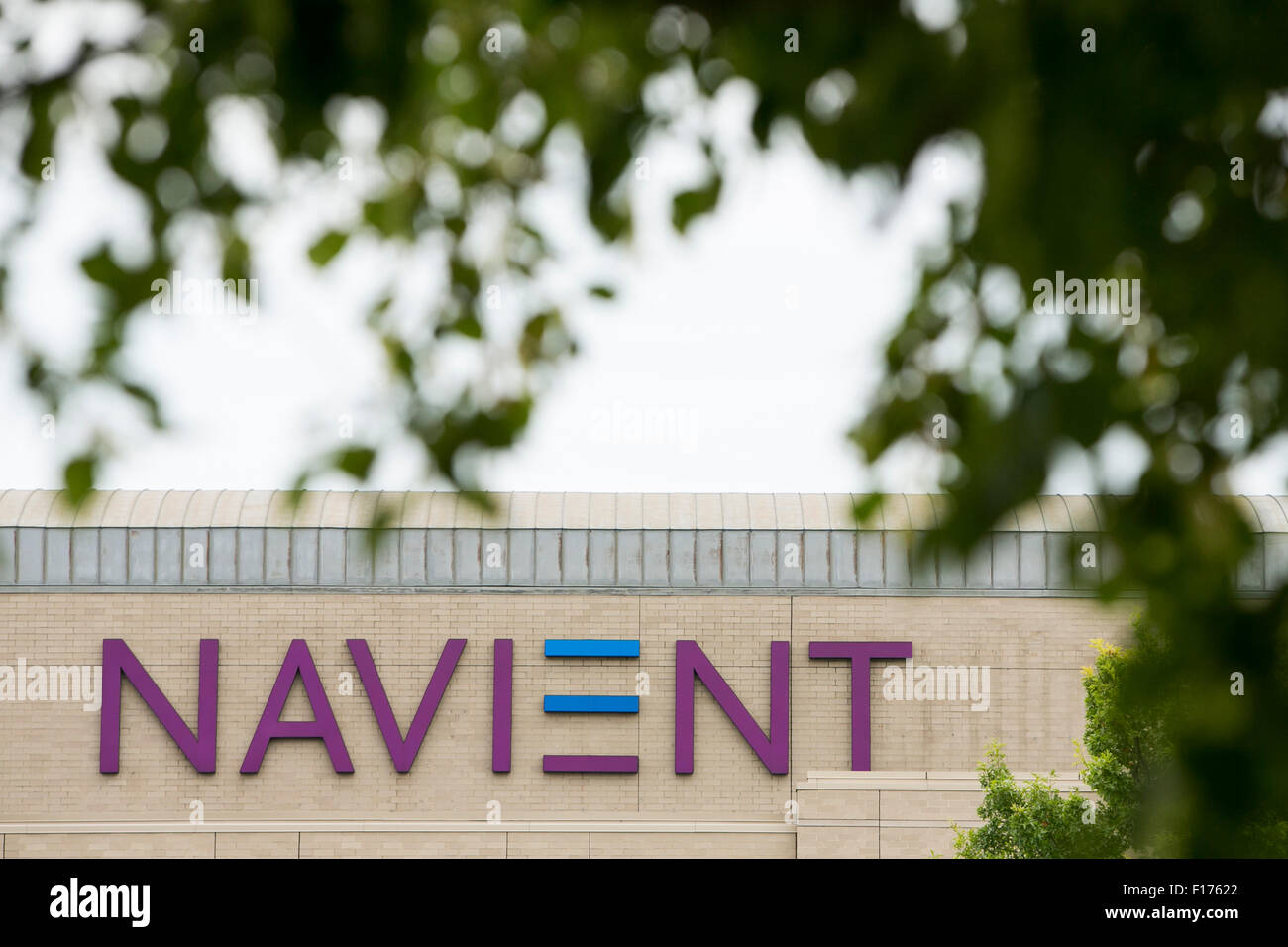A logo sign outside of a facility occupied by the Navient Corporation ...