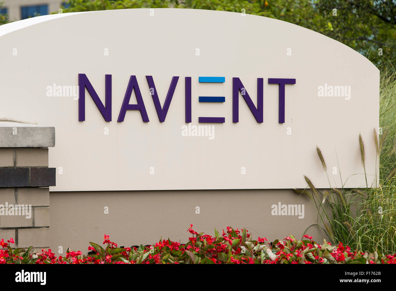 A logo sign outside of a facility occupied by the Navient Corporation ...
