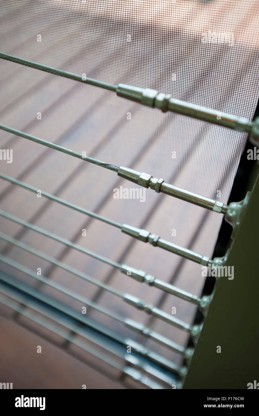 turn buckle cables make a safety railing on a screened in porch Stock ...