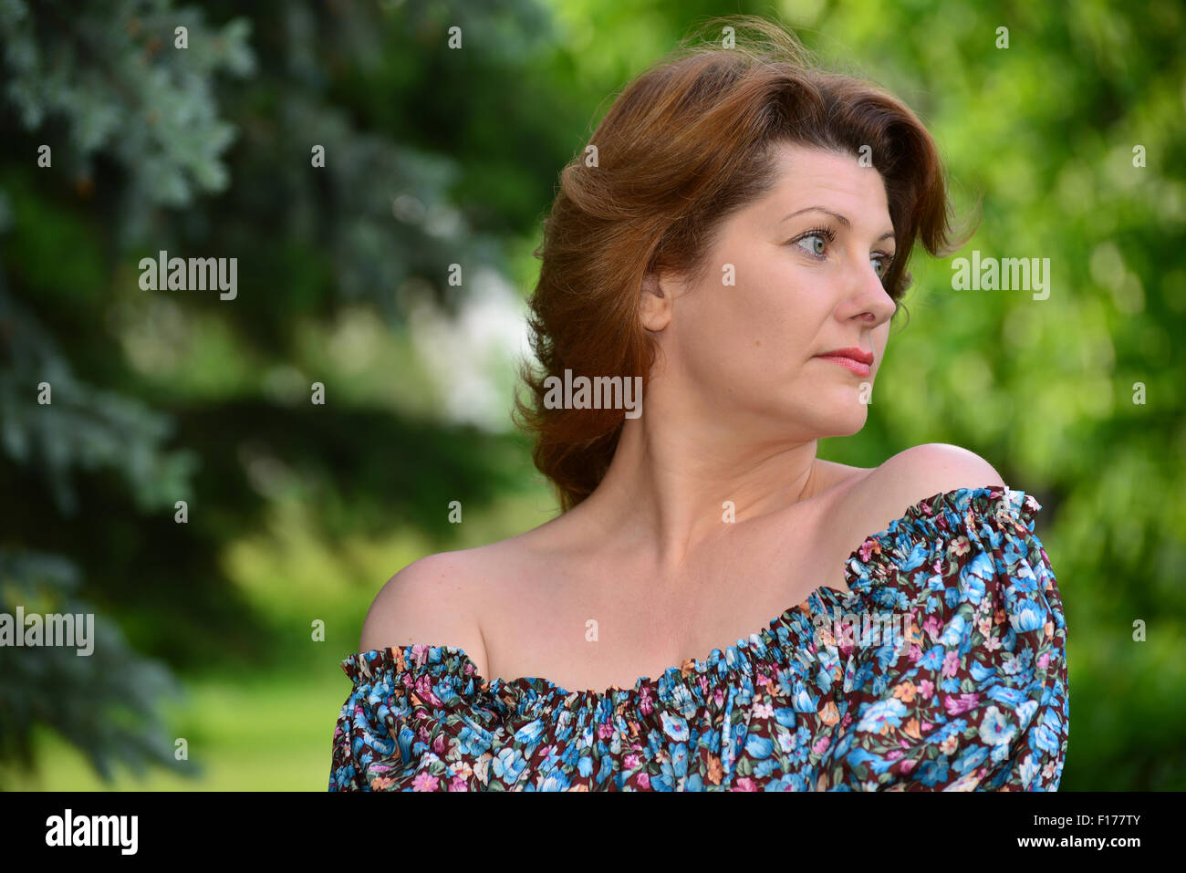 woman in a dress with open shoulders at pine forest Stock Photo - Alamy