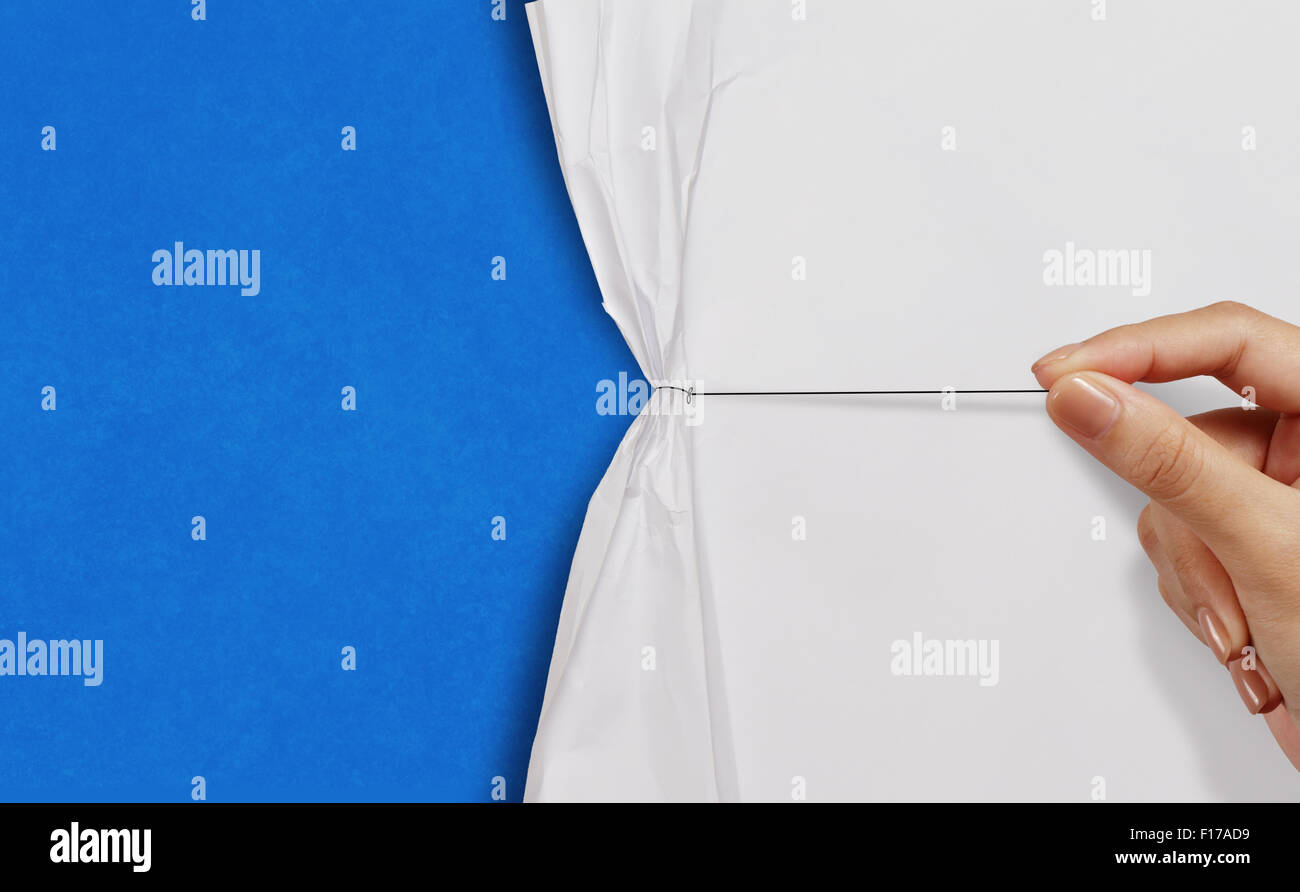 hand pull rope open wrinkled paper show blue background as business ...