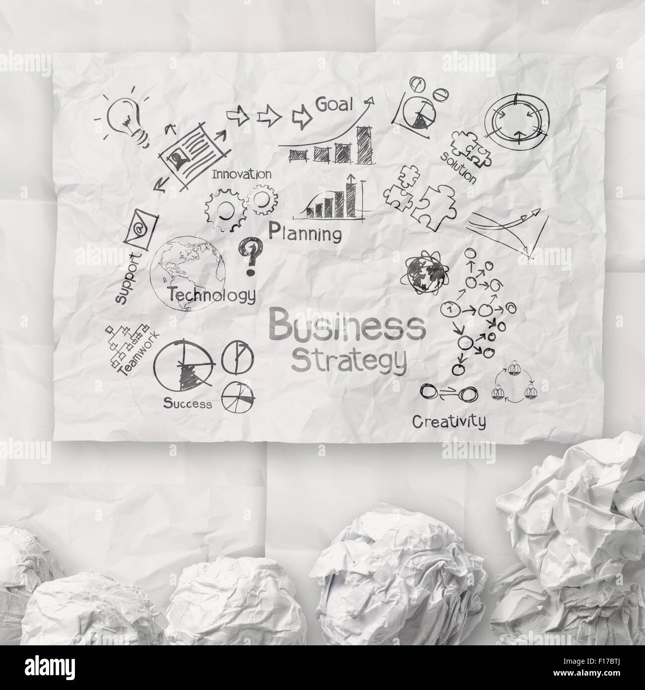 hand drawing creative business strategy on crumpled paper background as ...