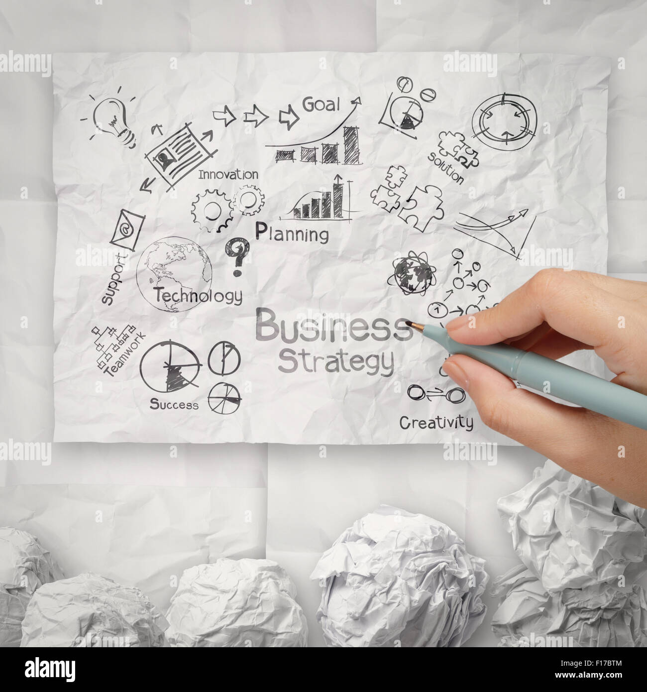 hand drawing creative business strategy on crumpled paper background as ...