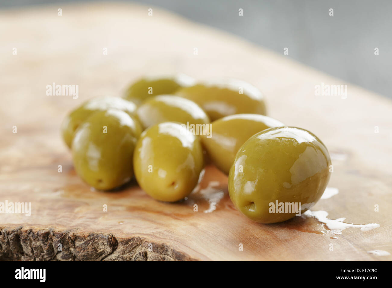 green huge olives on wood table Stock Photo - Alamy