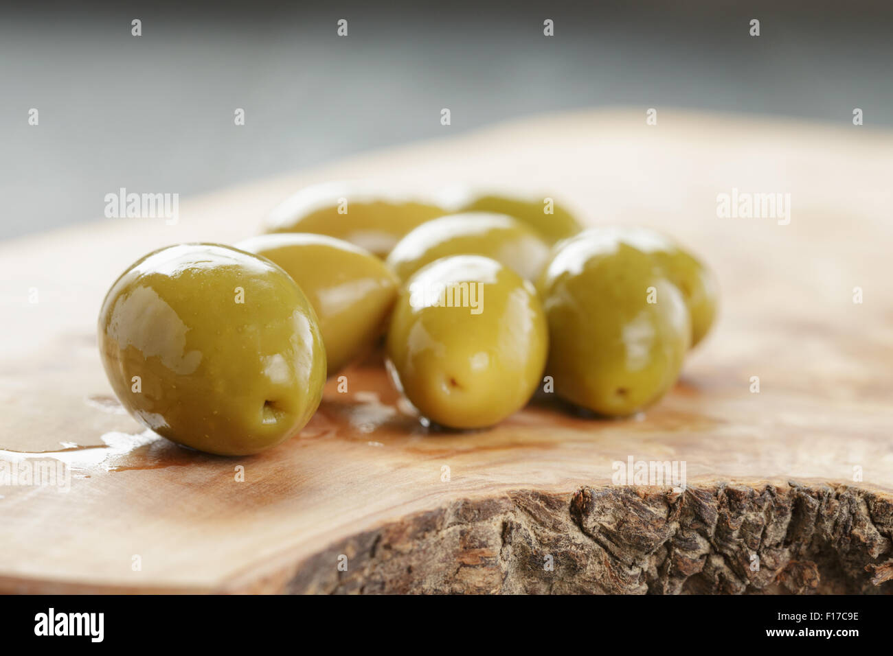 green huge olives on wood table Stock Photo - Alamy