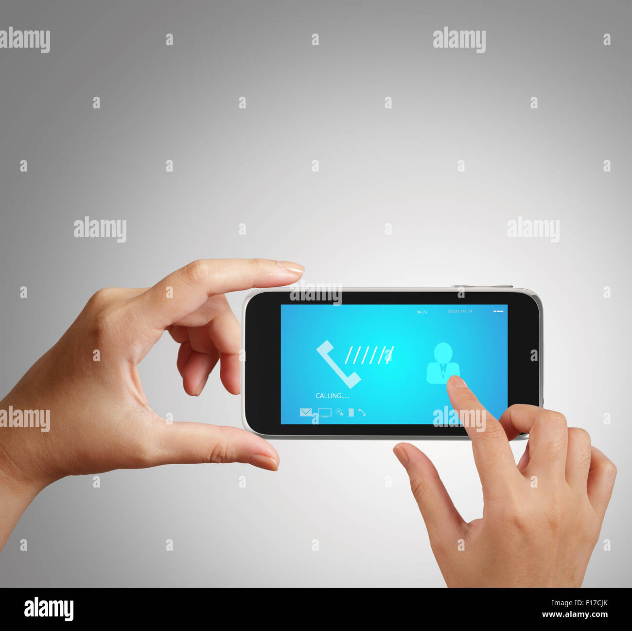 hand holding a touch phone with blue screen and the phone ringing icon ...