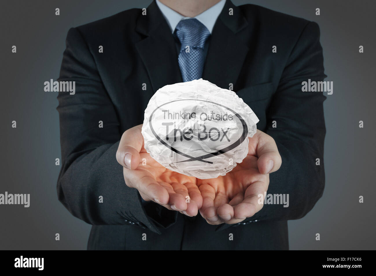 hand shows crumpled paper and think outside the box as concept Stock ...