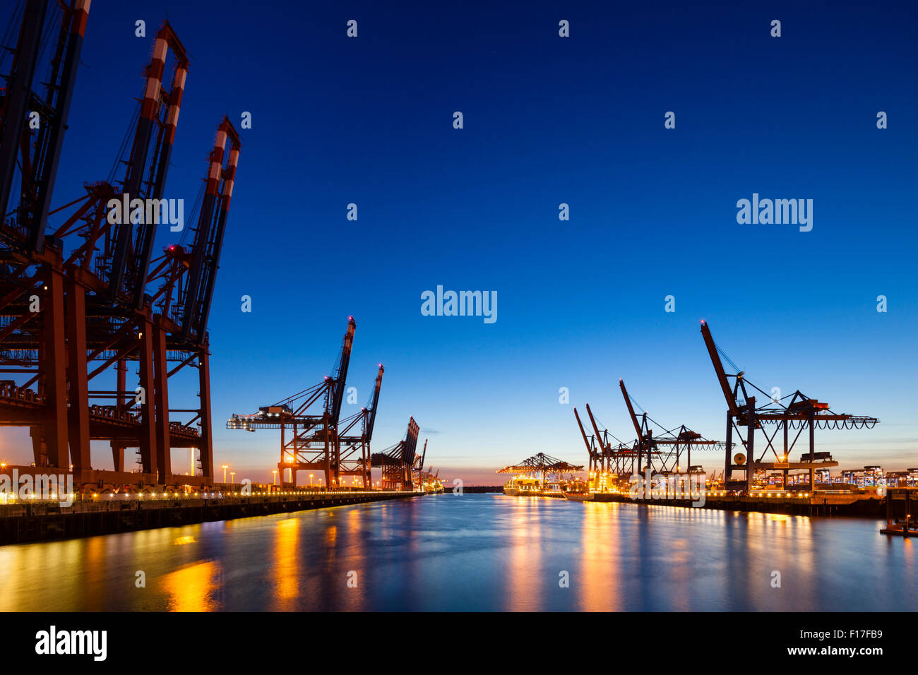 A large container harbor with deep blue night sky, taken with a shift ...