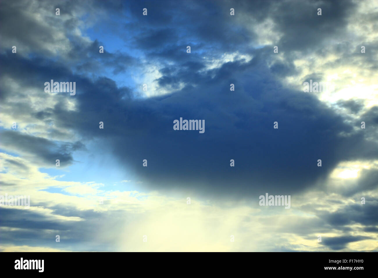 cloud with unusual shape and sunny beams Stock Photo - Alamy