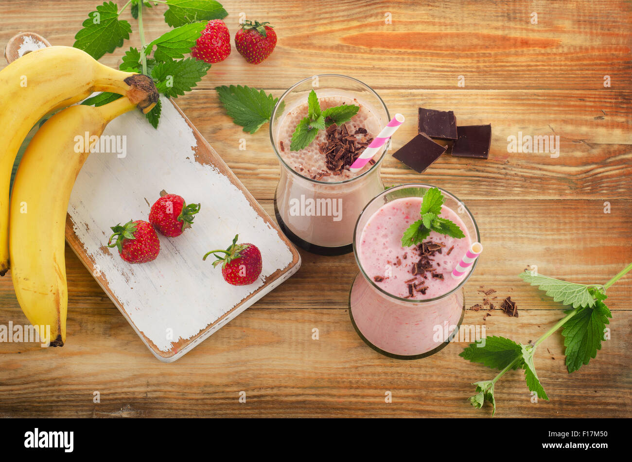 Smoothies with strawberry and banana on a wooden table. Top view Stock ...