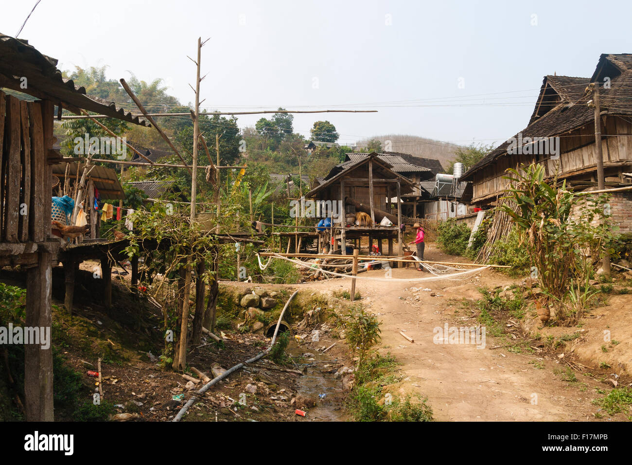A rural village in Xishuangbanna, Yunnan, China where women are weaving ...