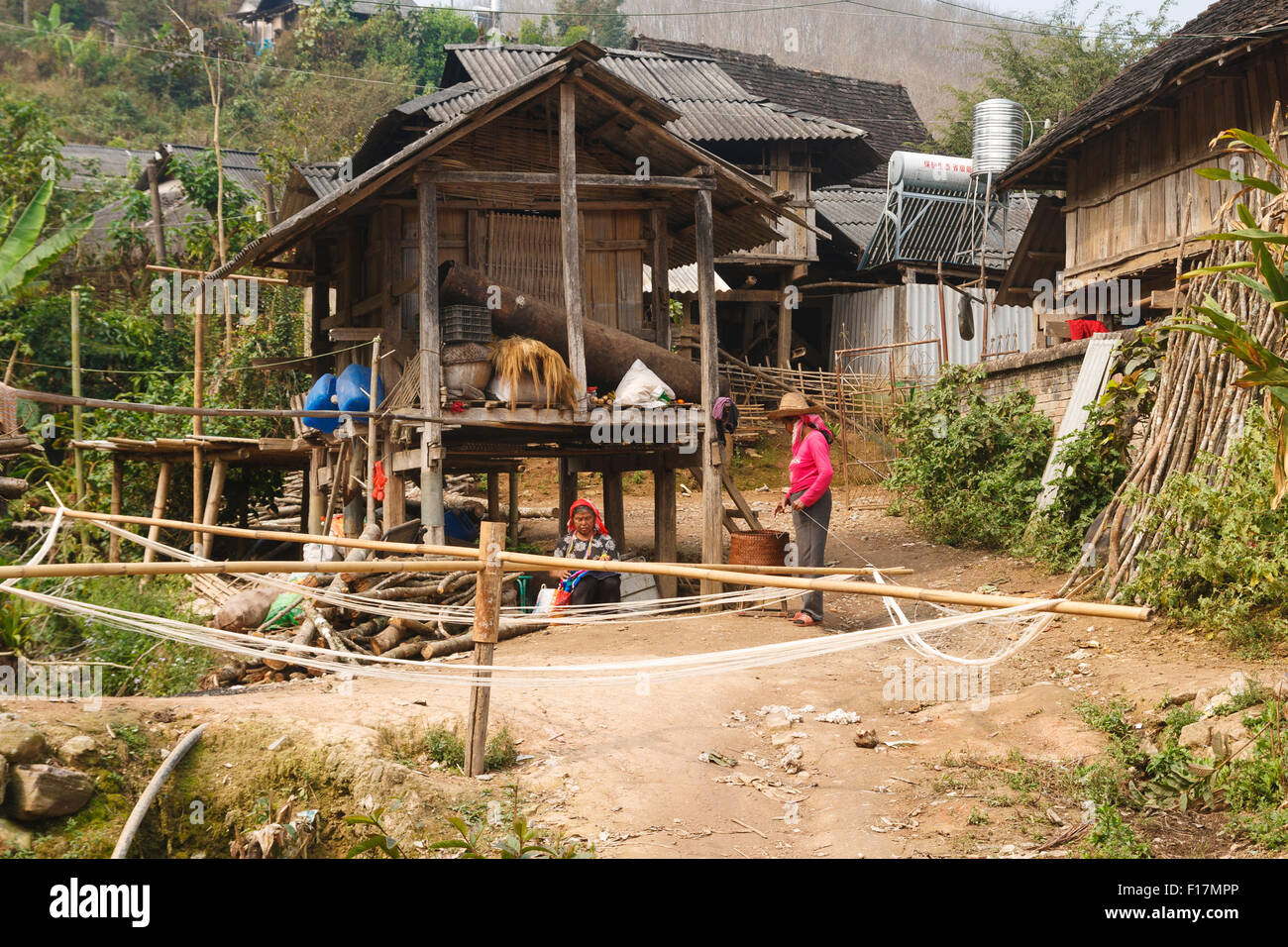 Rural village in Xishuangbanna, Yunnan, China, where women are weaving ...