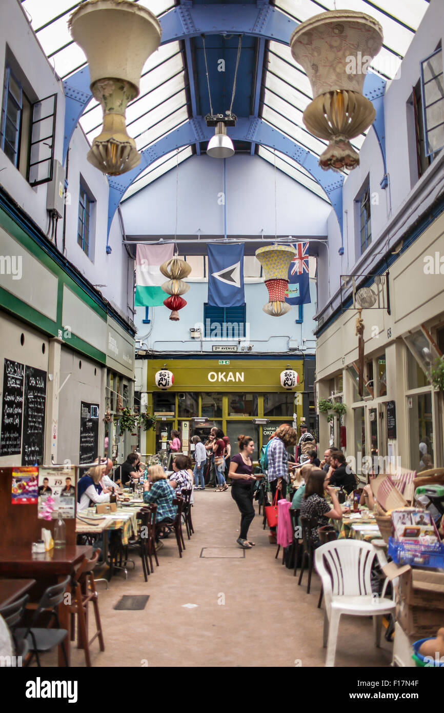 Brixton Village market, London, UK. People enjoy food and drink in ...
