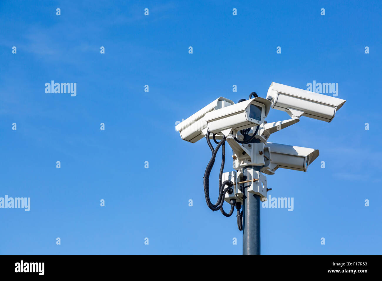 Four CCTV surveillance cameras on a pole Stock Photo - Alamy