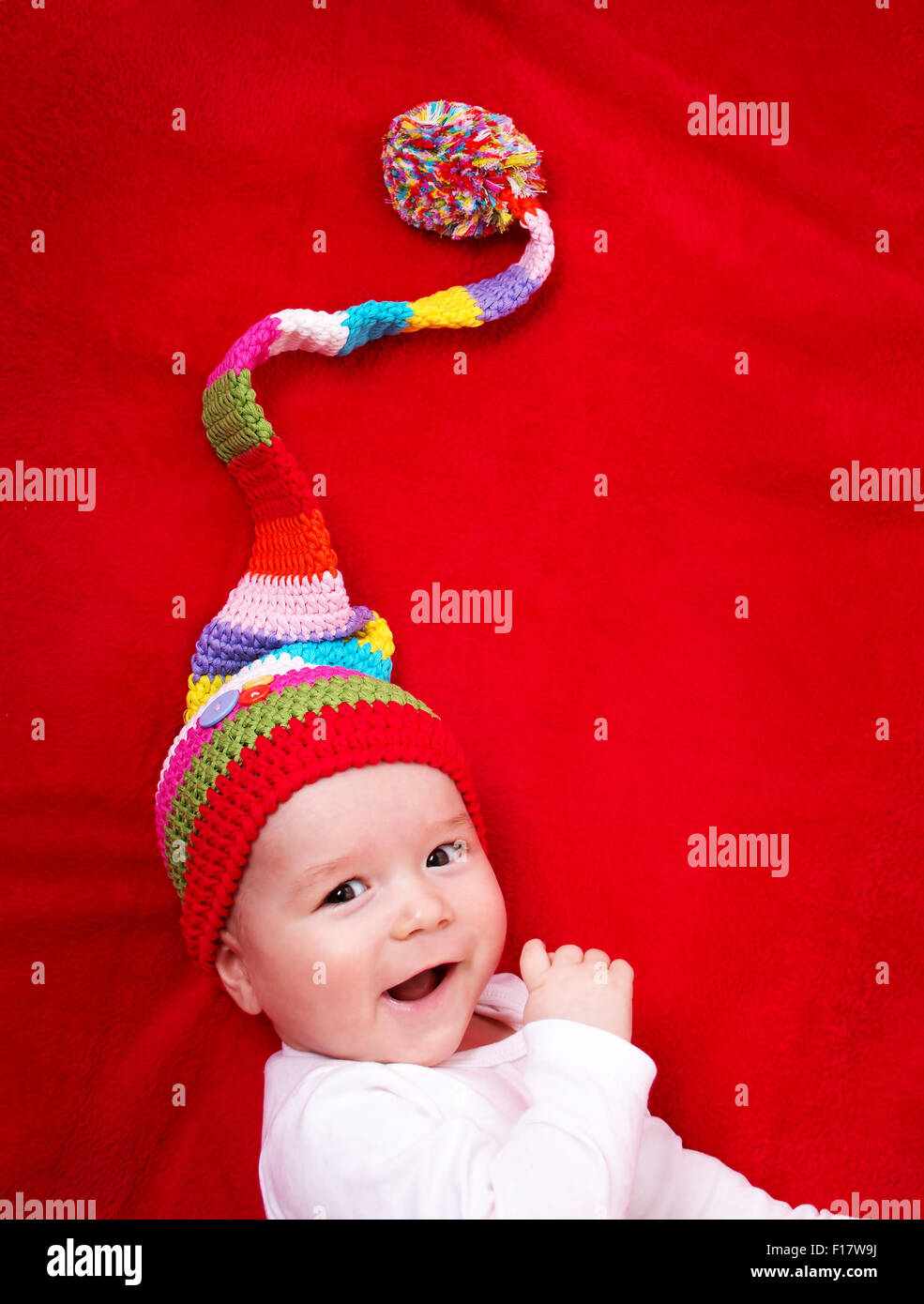Baby in red and white hat Stock Photo - Alamy