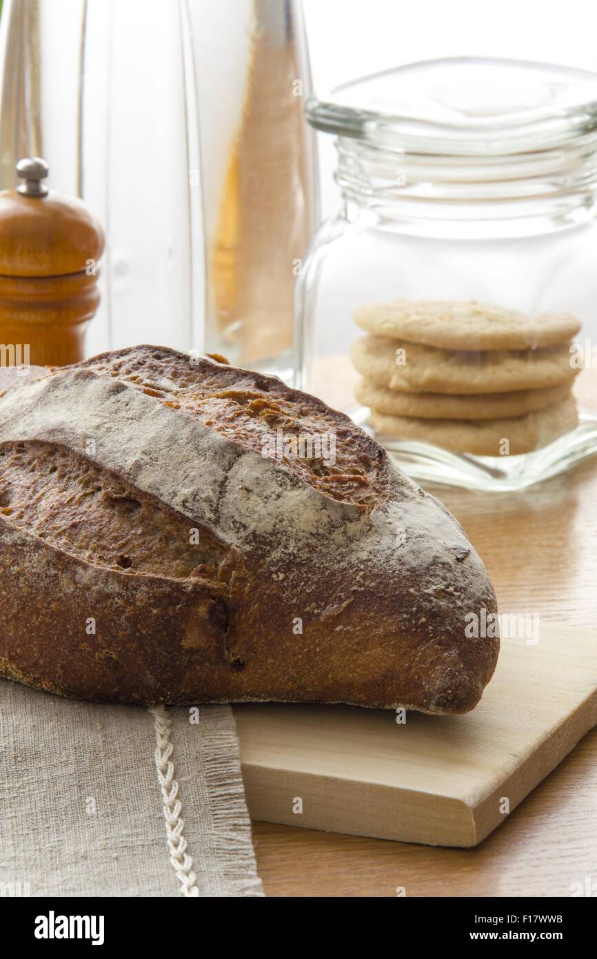 Fresh Tradition bread loaf on the kitchen table with cakes jar and ...