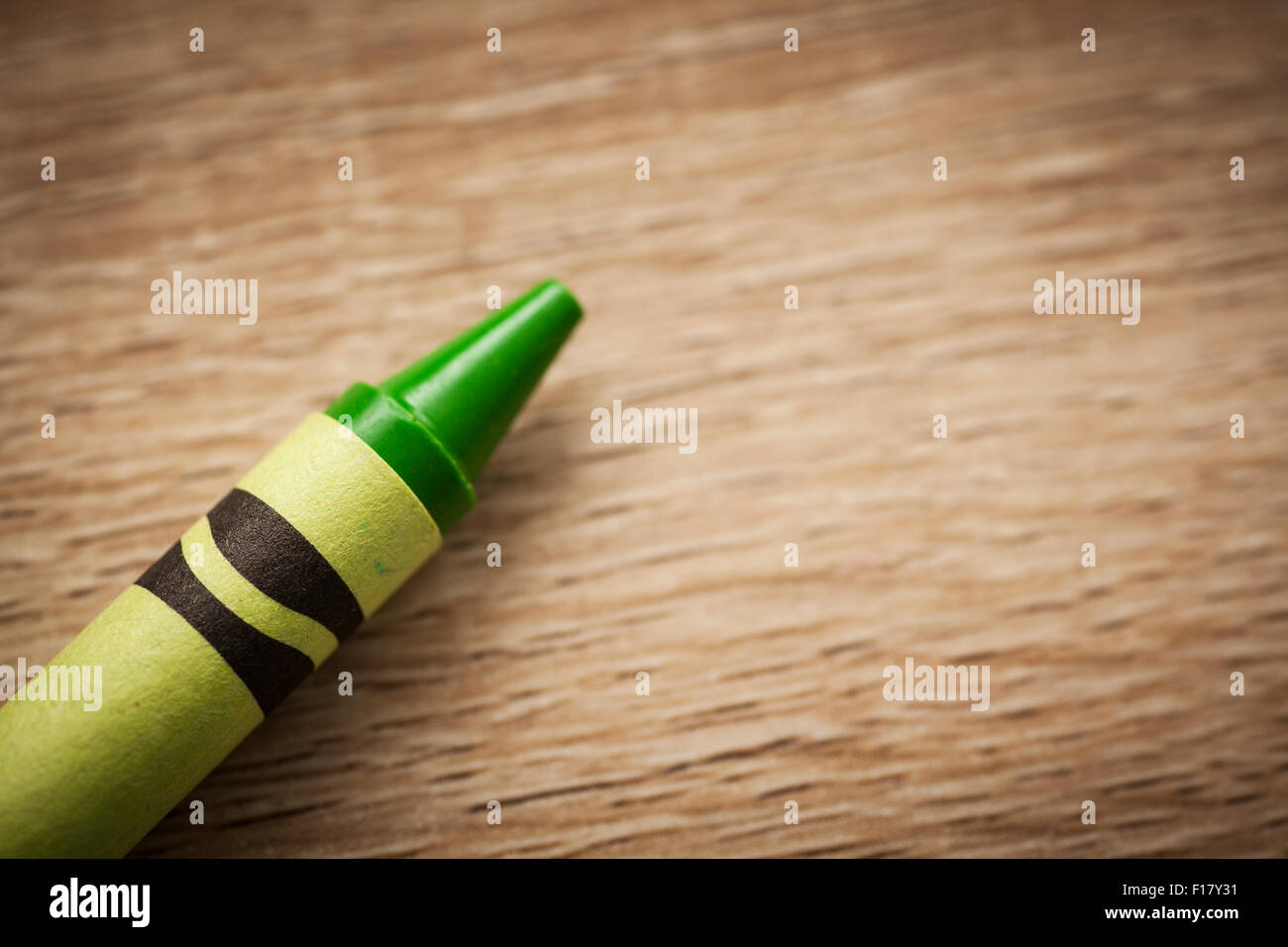 Single green wax crayon on a wood textured bacground / surface Stock ...