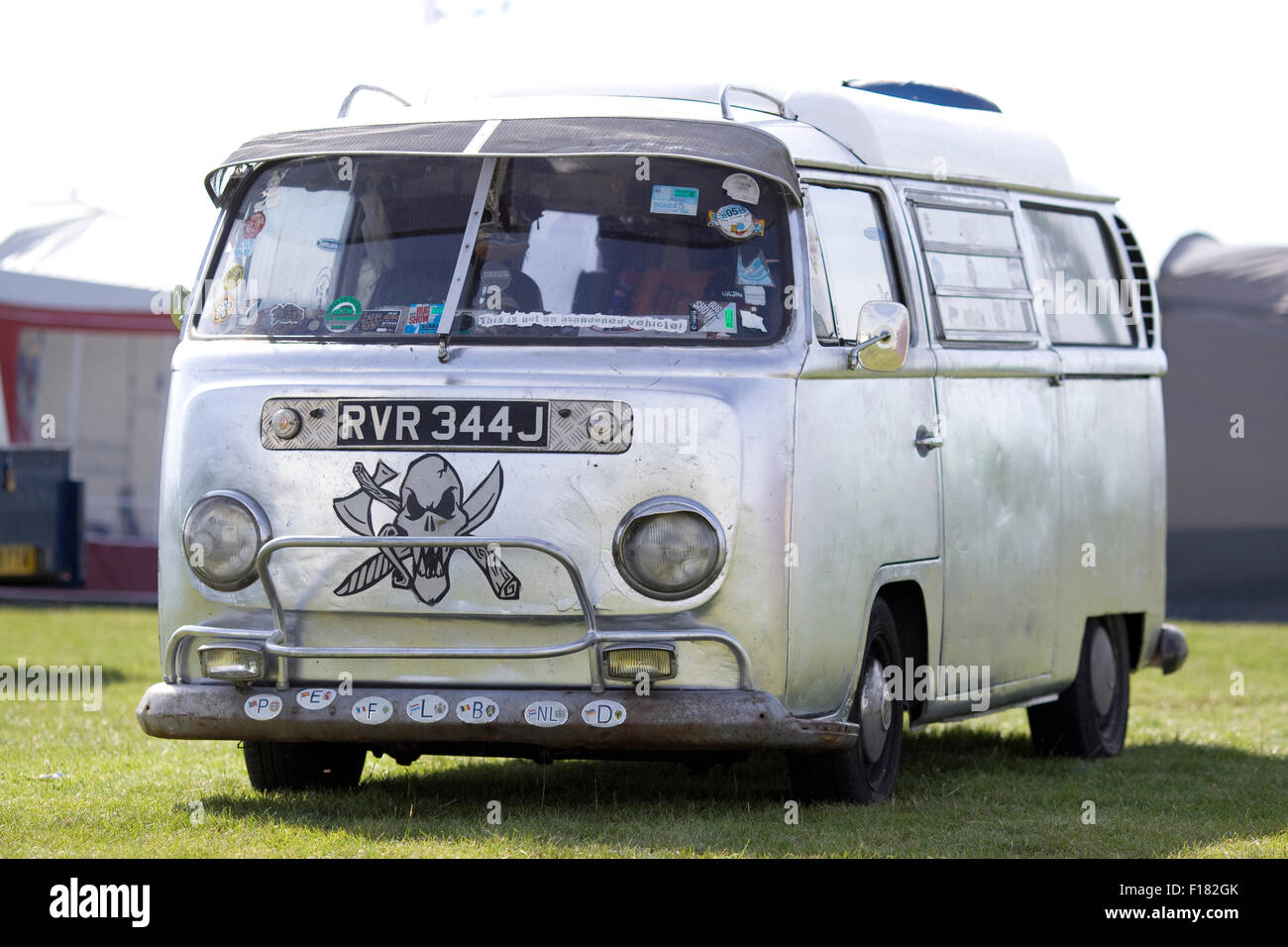 Silver split screen Camper van Parked on a campsite and VW Action Stock ...