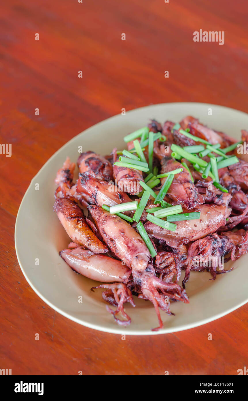 plate of sauteed small squid fried with garlic and sauce Stock Photo ...