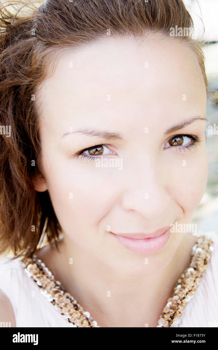 Closeup portrait of a beautiful young brunette woman Stock Photo - Alamy