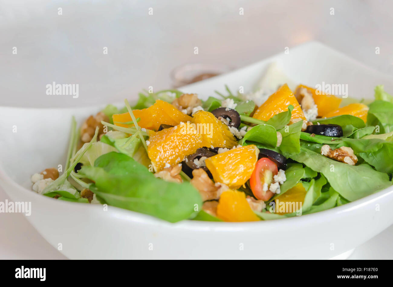 rocket salad with Parmesan cheese and orange fruit Stock Photo - Alamy