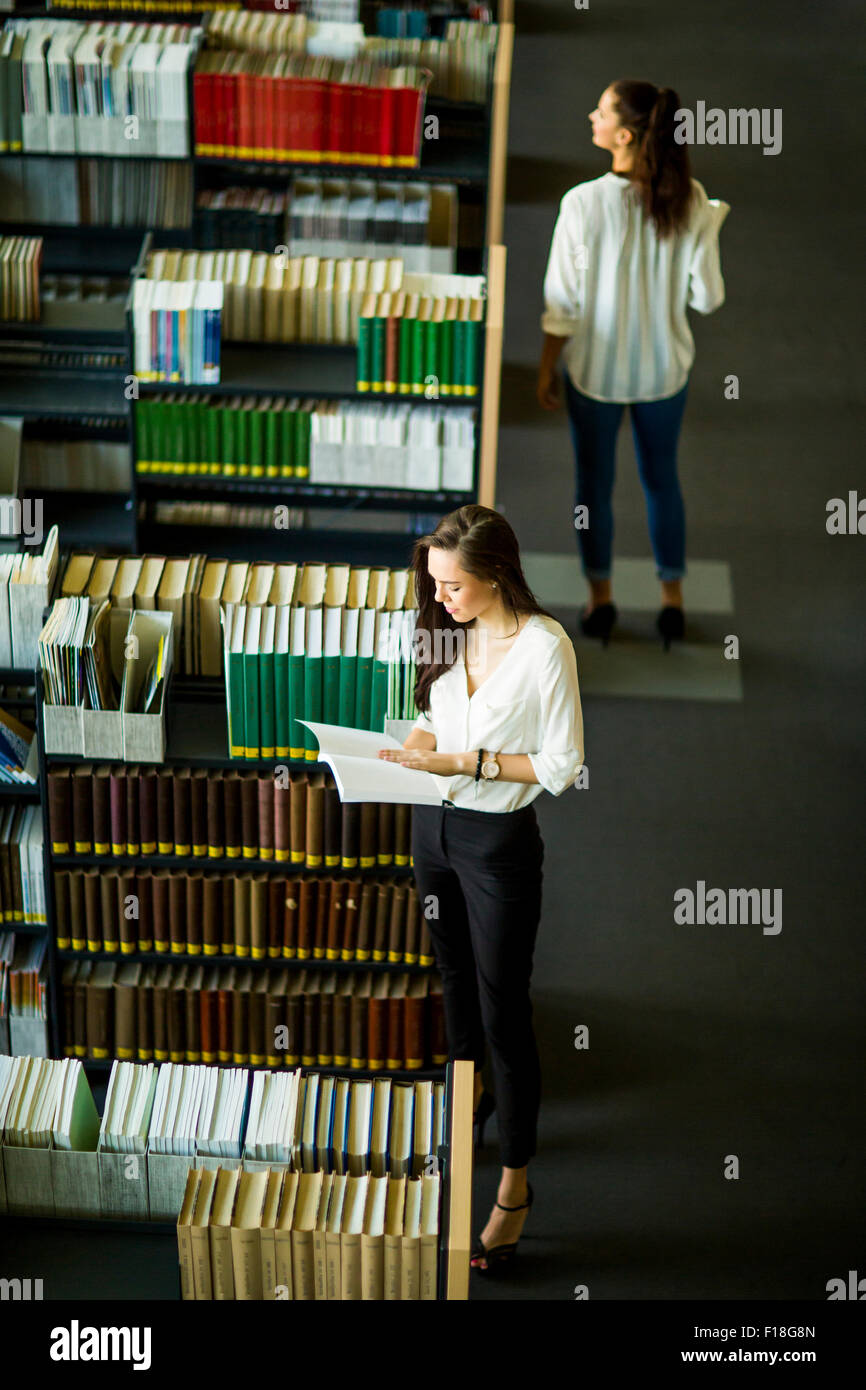 Young women in the library Stock Photo - Alamy