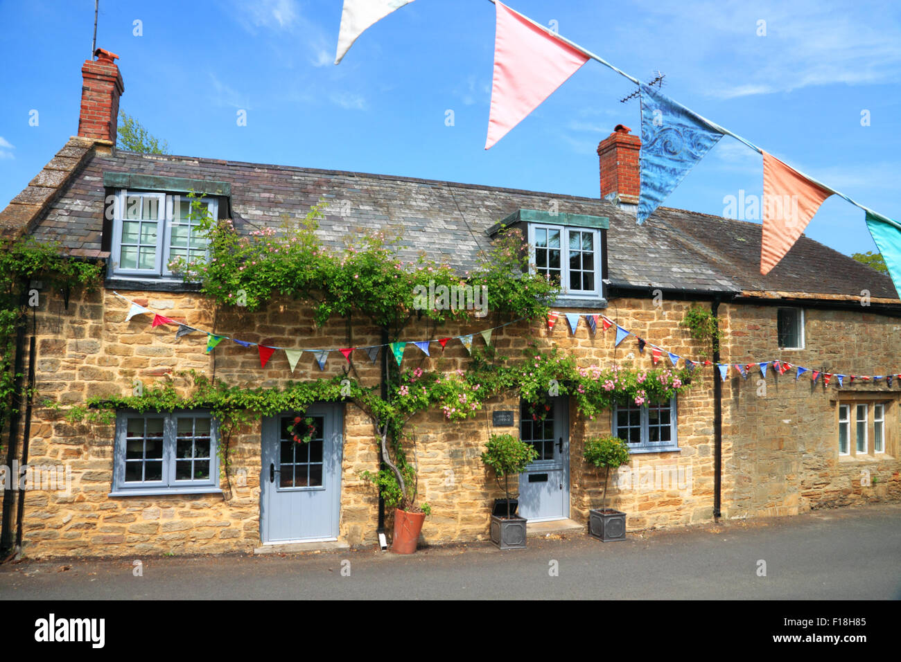 Stone cottages draped with bunting Stock Photo - Alamy