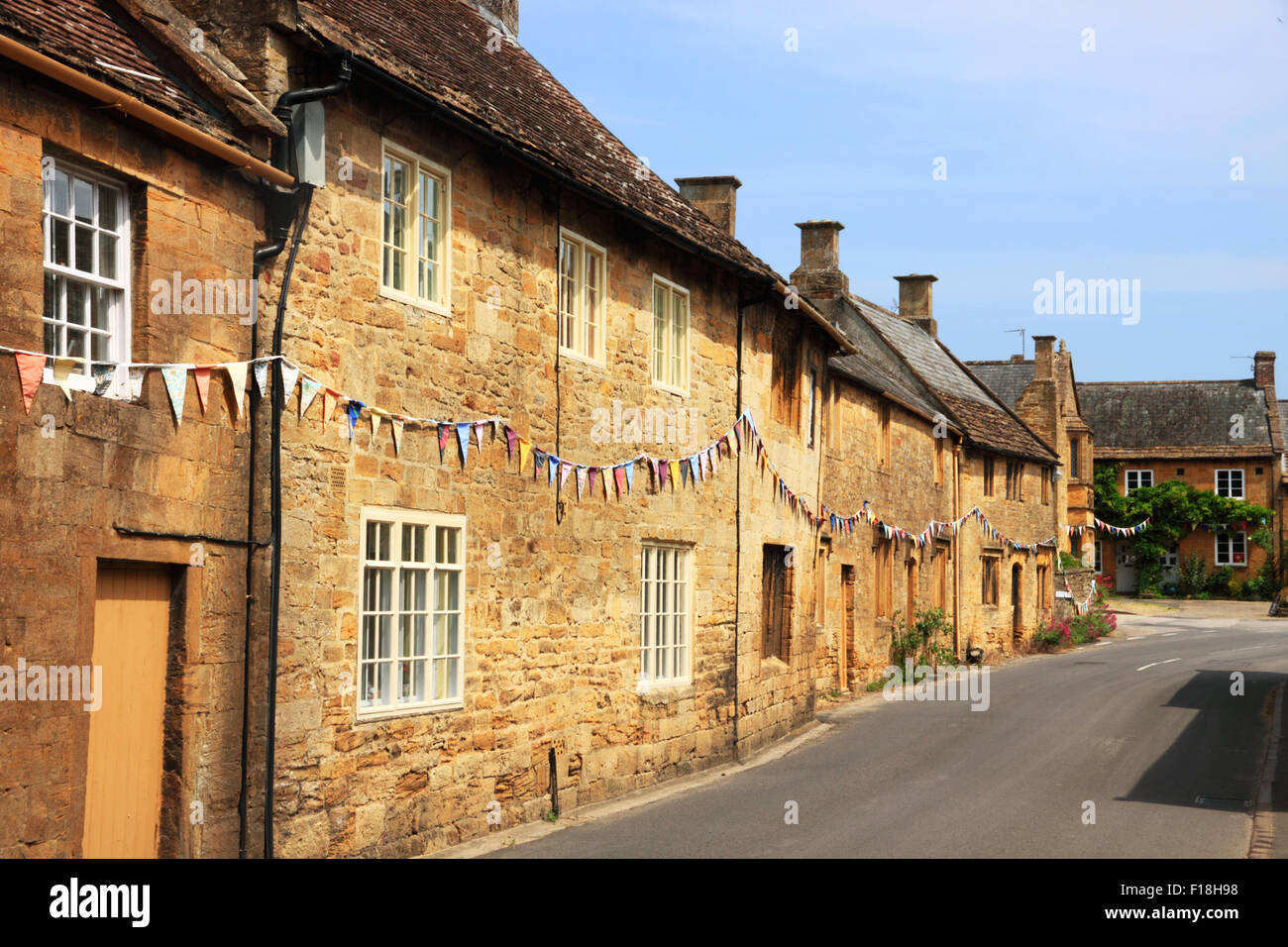 Stone cottages draped with bunting Stock Photo - Alamy