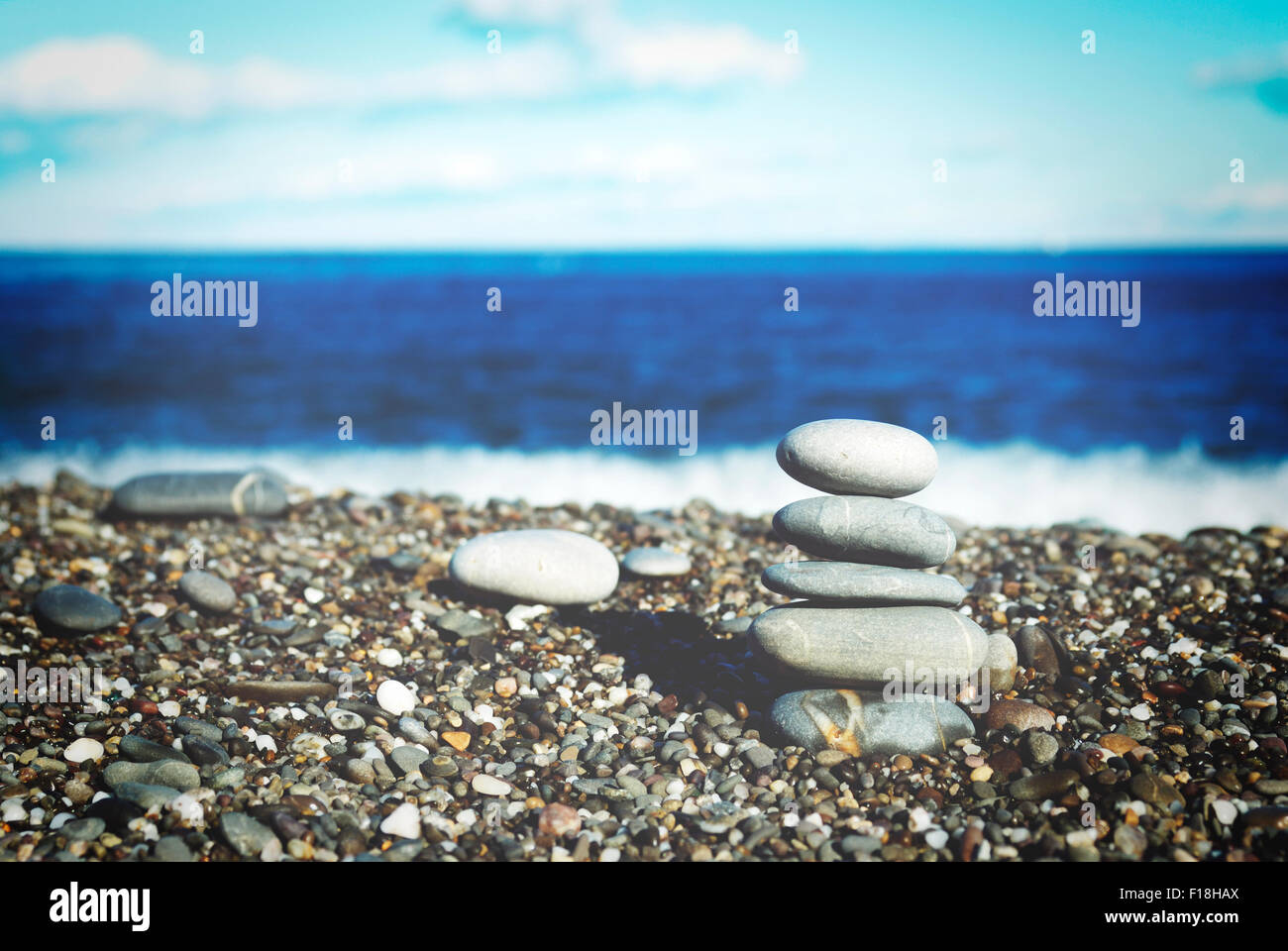 Beautiful view on the beach and column of sea stones Stock Photo - Alamy