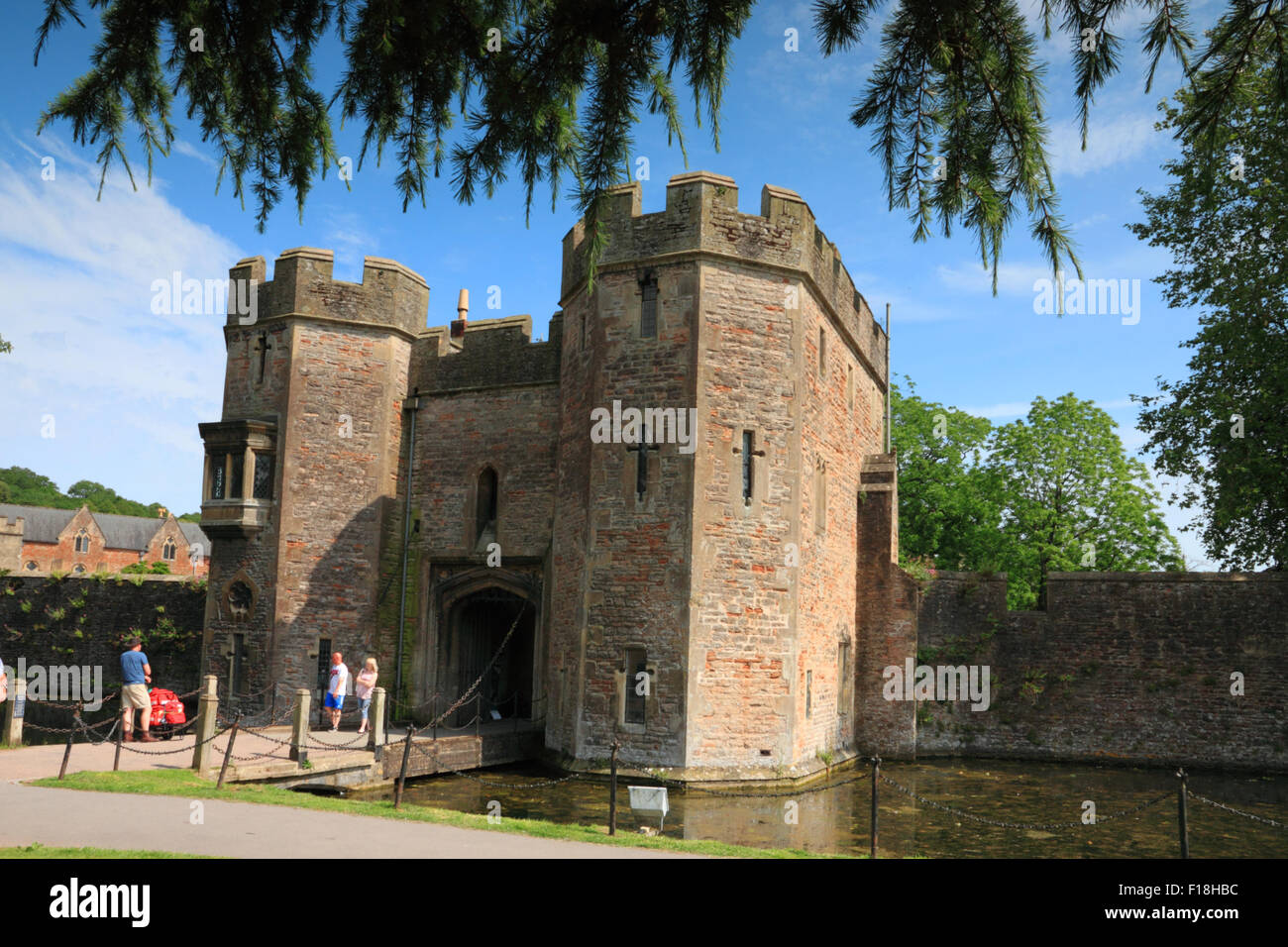 A gatehouse with twin turrets over a drawbridge and moat Stock Photo ...
