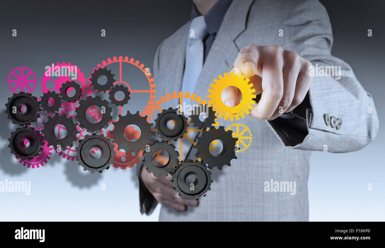 businessman hand makes colorful gear to success concept Stock Photo - Alamy