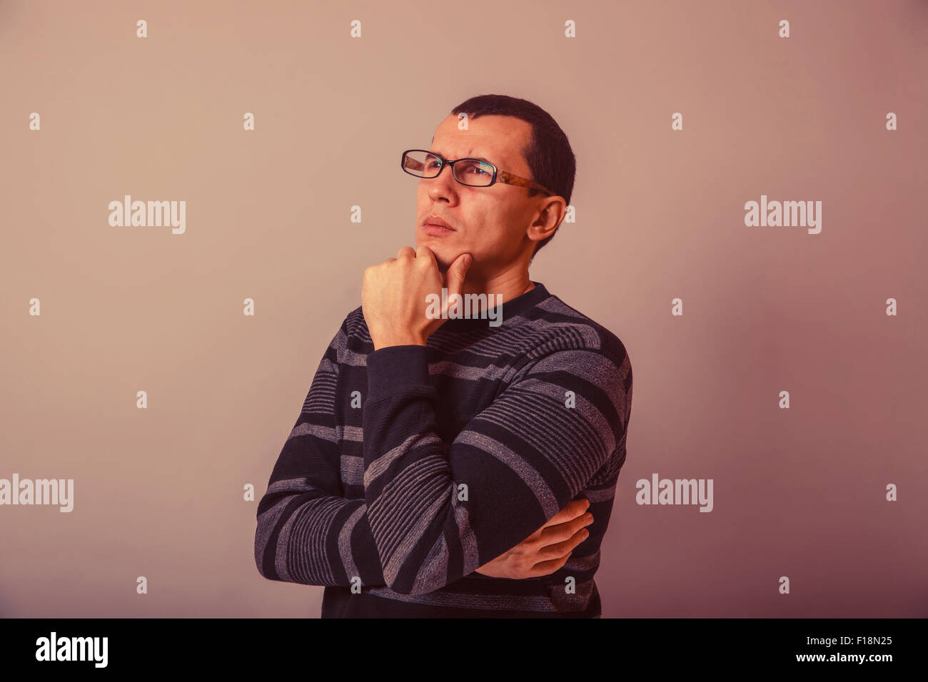 European-looking man of 30 years in glasses, thinking retro Stock Photo ...