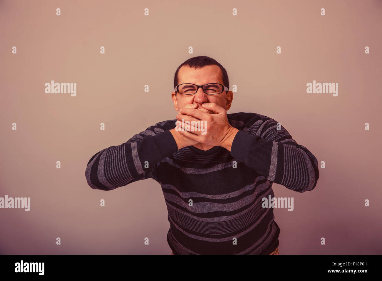 European-looking man of 30 years with glasses, closed his mout Stock ...
