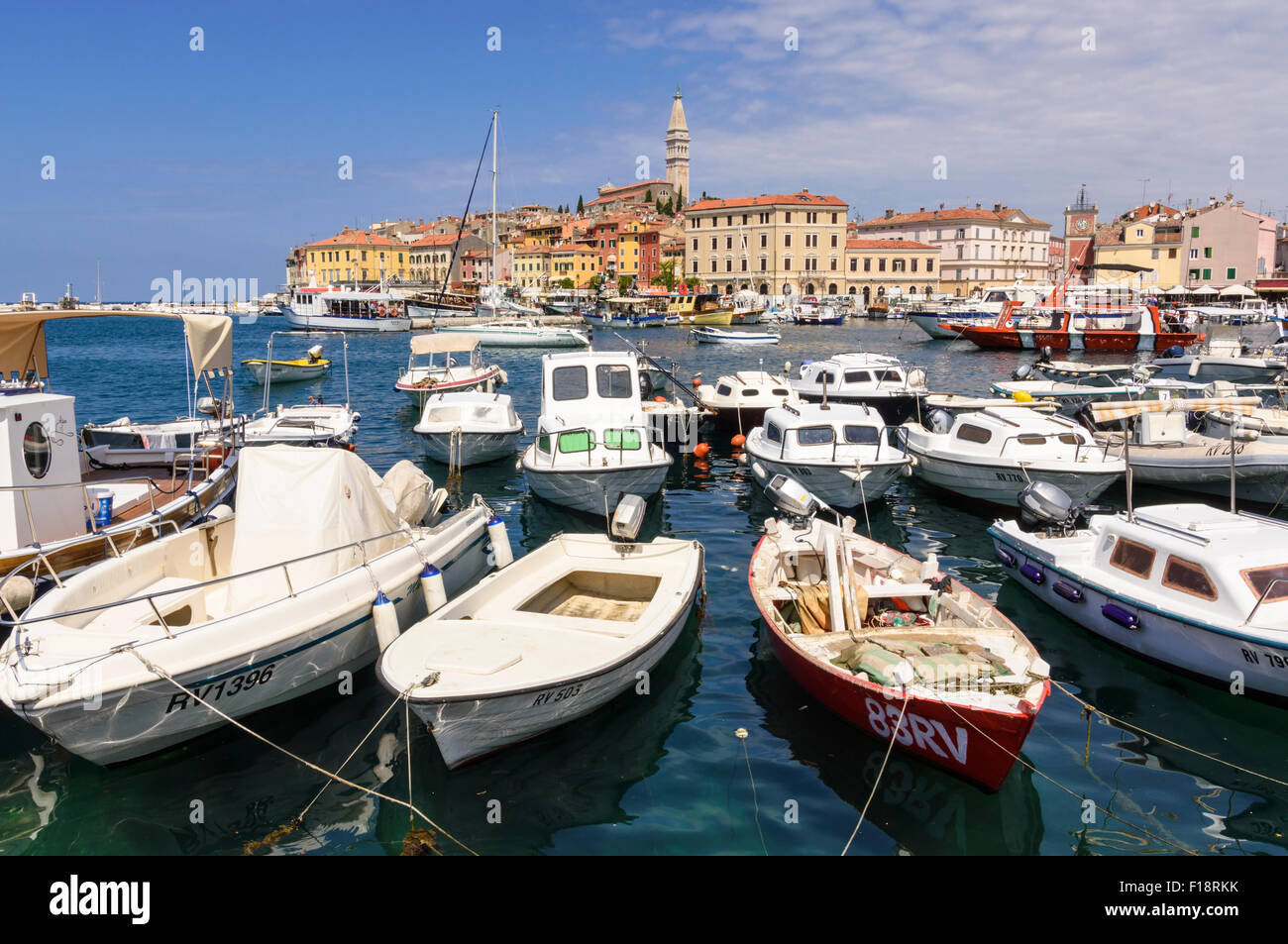 Rovinj town moored boats in the harbour, overlooked by the colourful ...