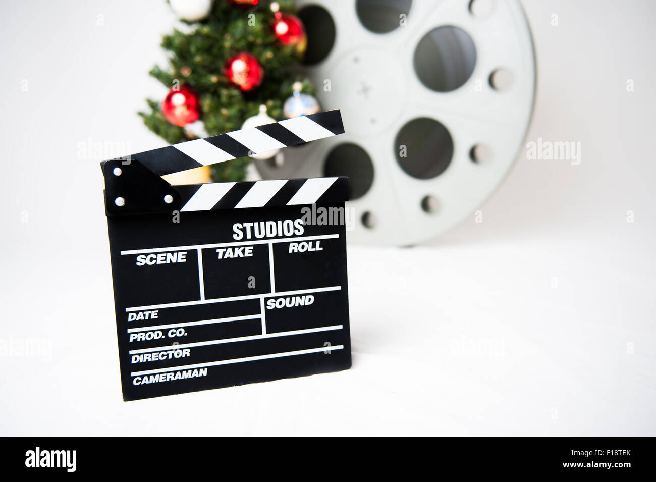 Movie clapper board with christmas tree and reel Stock Photo - Alamy