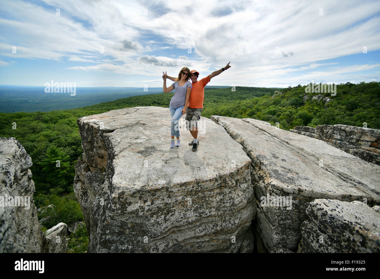 Man standing on cliff ledge hi-res stock photography and images - Alamy