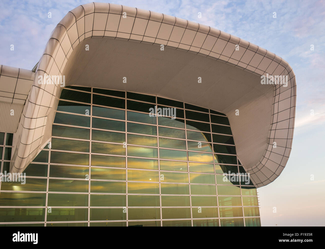 passenger plane fly up over take-off runway from airport at sunset ...