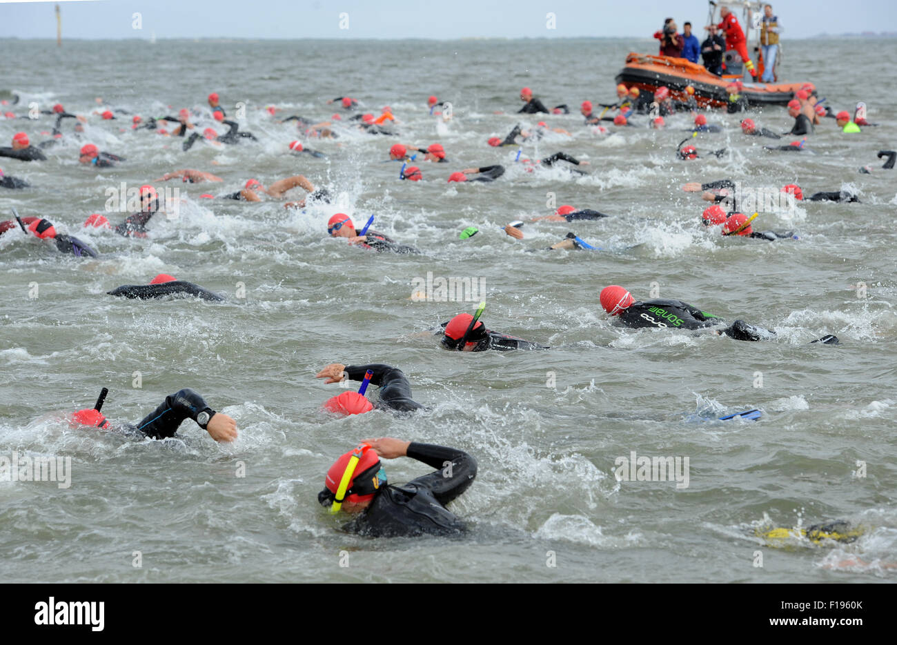 Hilgenriedersiel, Germany. 30th Aug, 2015. Hundreds of swimmers start the 27th island swim to ...